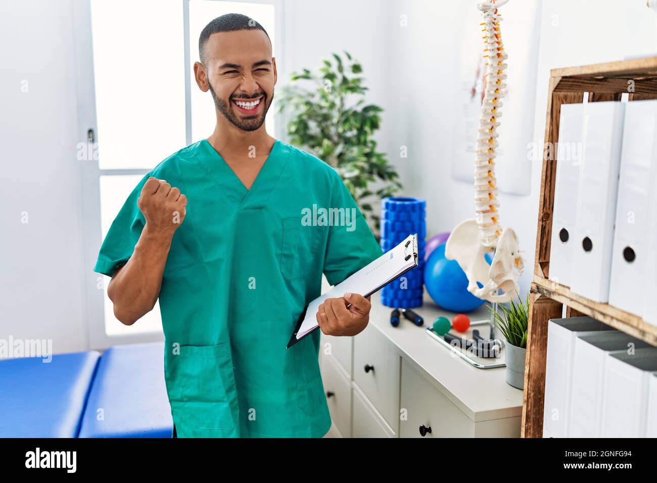 African american physiotherapist man working at pain recovery clinic ...