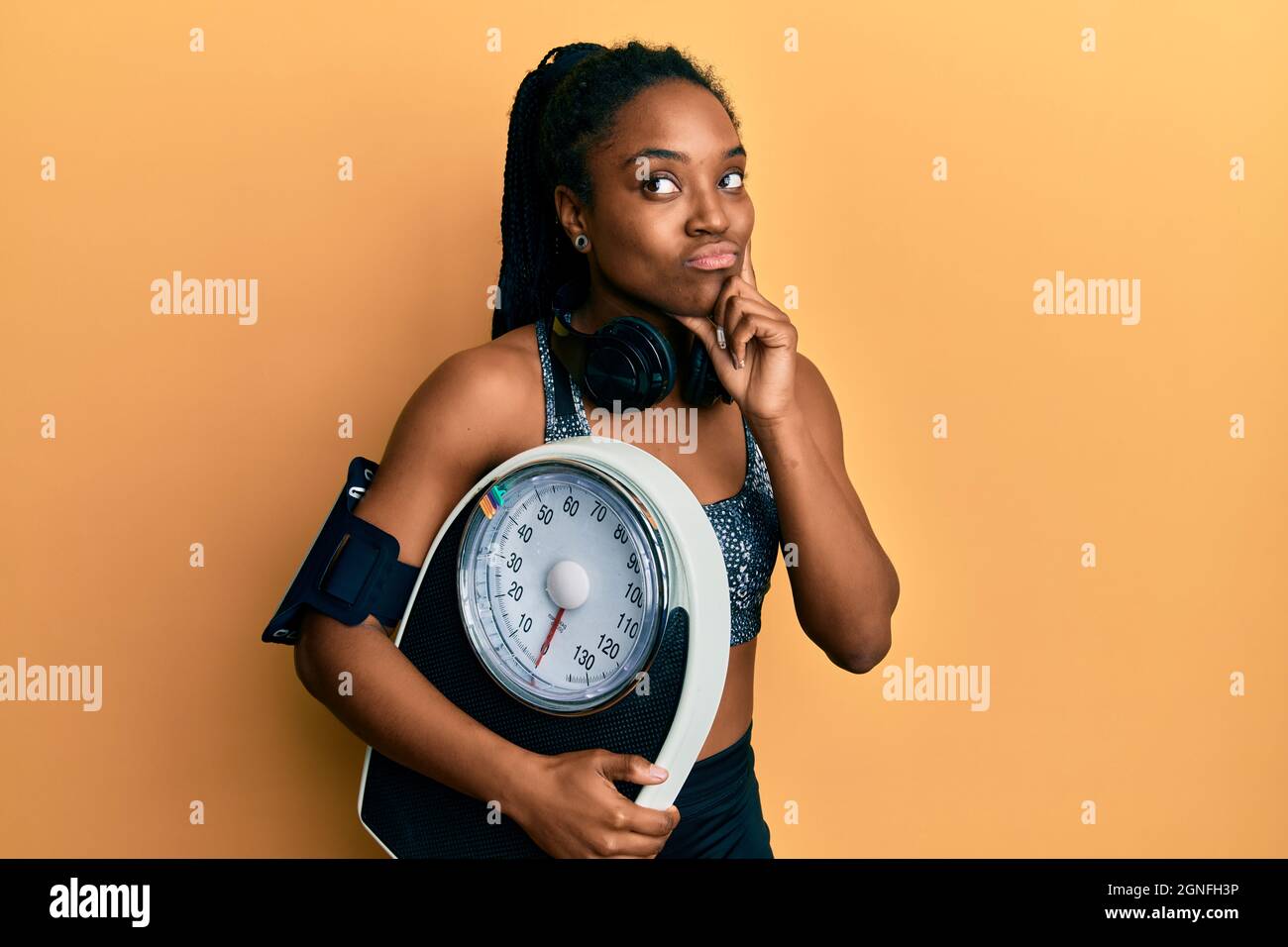 African american woman with braided hair wearing sportswear holding ...
