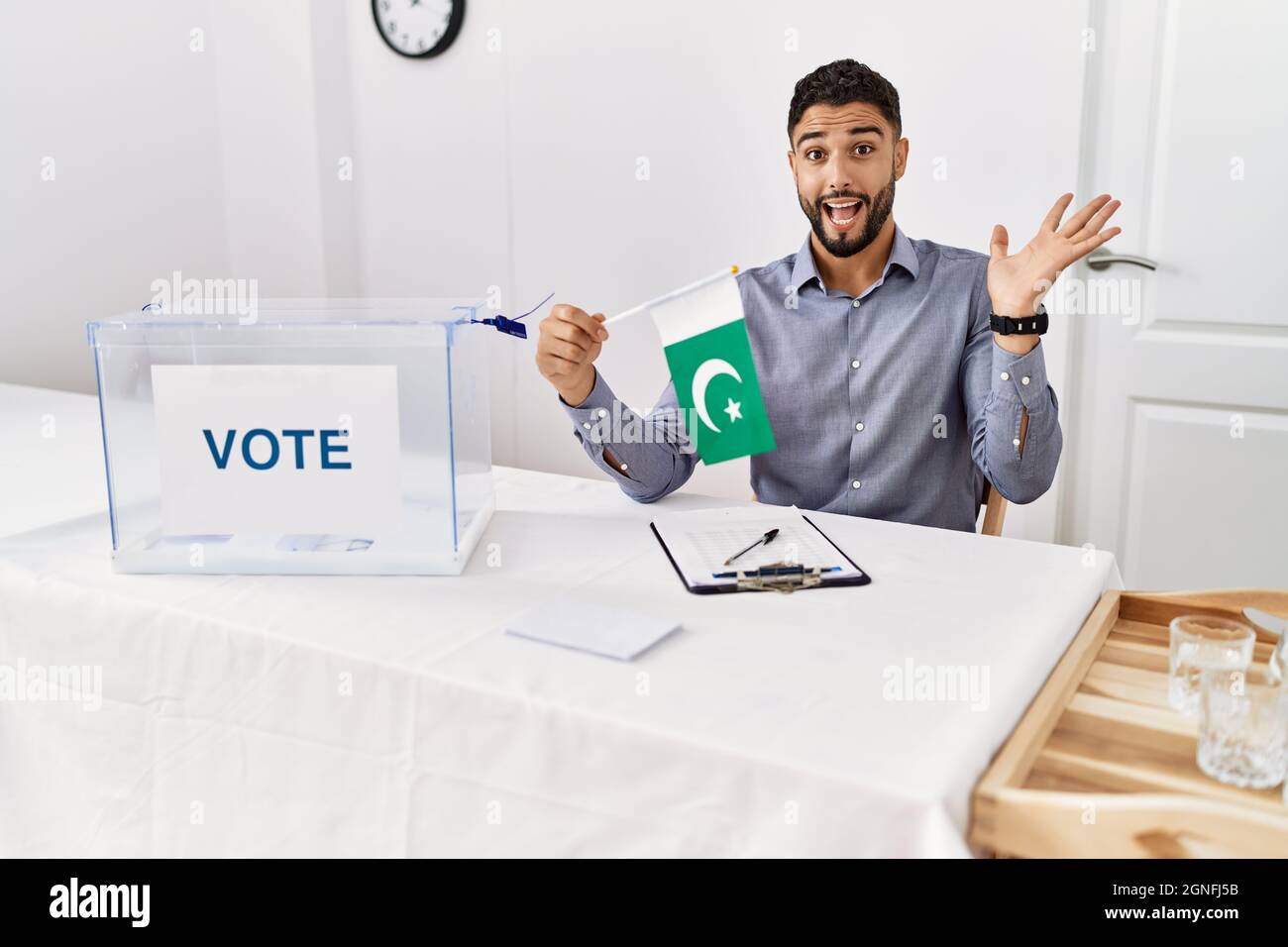 Young handsome man with beard at political campaign election holding ...
