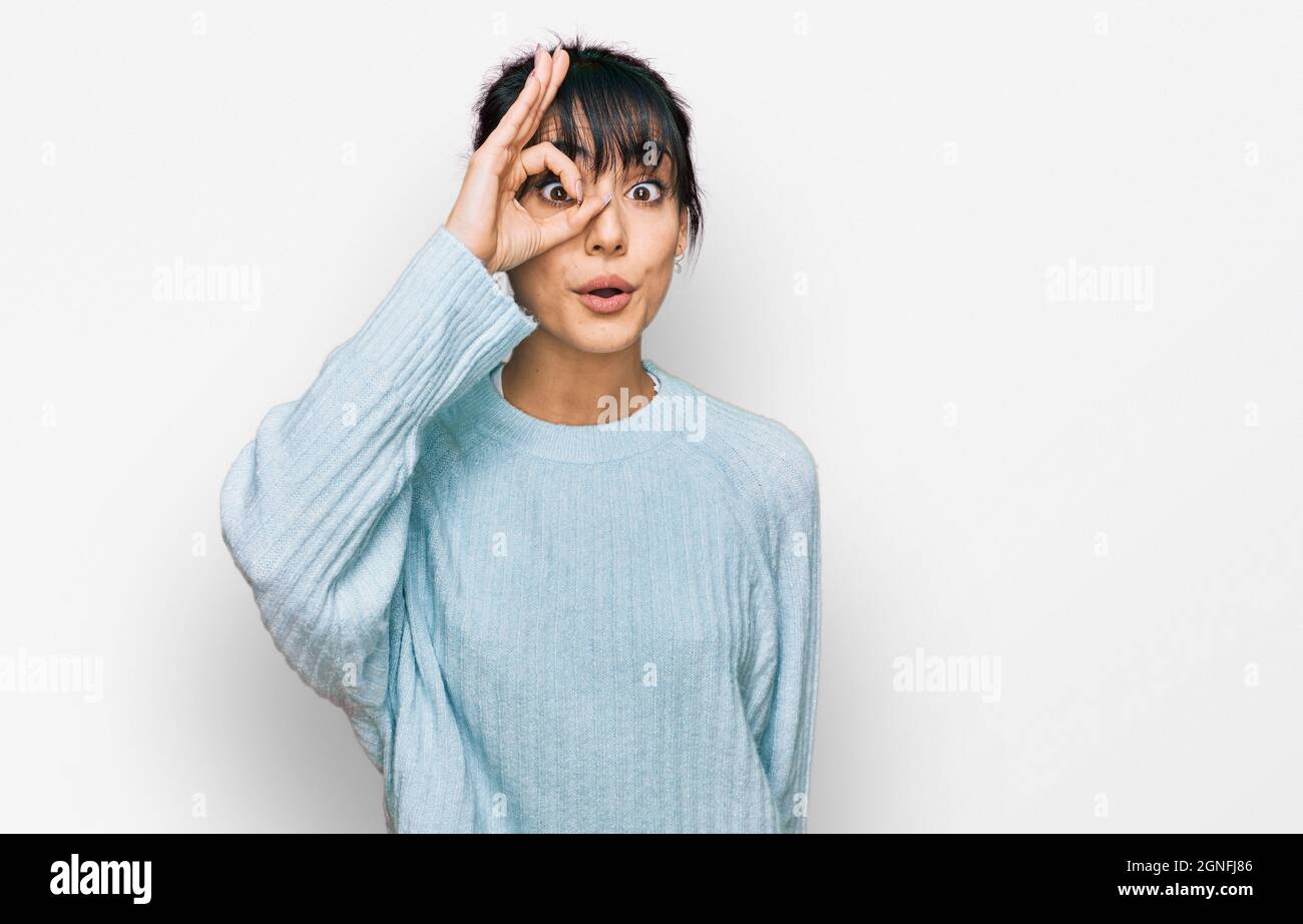 Young hispanic woman wearing casual clothes doing ok gesture shocked ...
