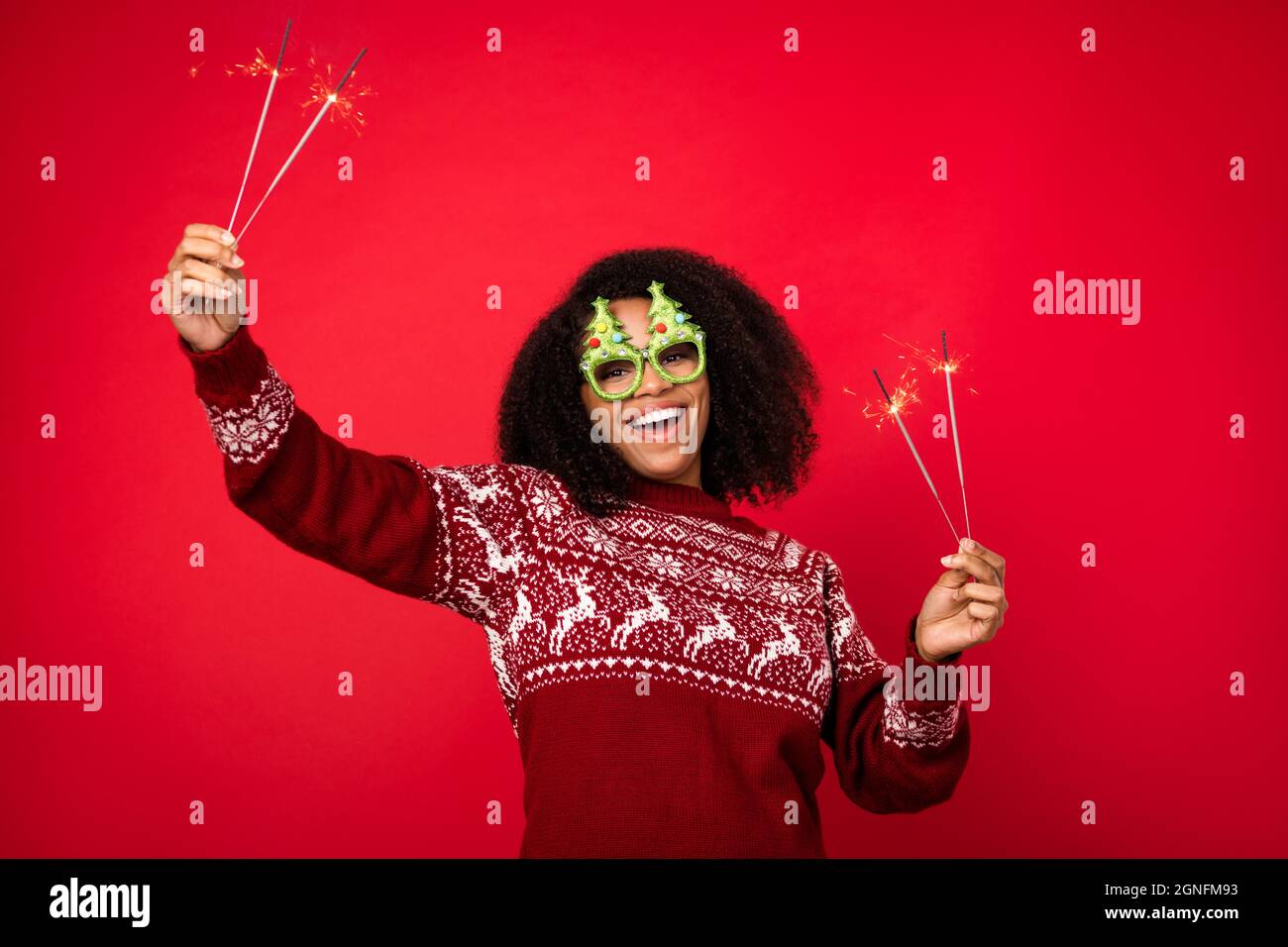 Portrait of attractive cheerful girl burning bengal fire having fun ...