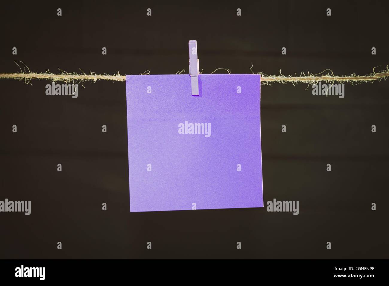 The paper for the text is suspended from a rope. Photo frames hanging ...