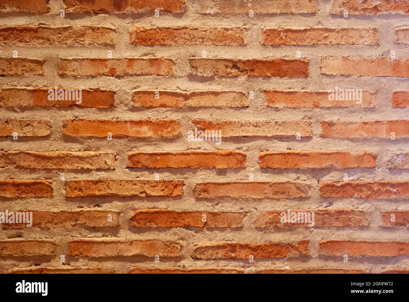 Rustic red orange brick wall with cement for background and space for ...