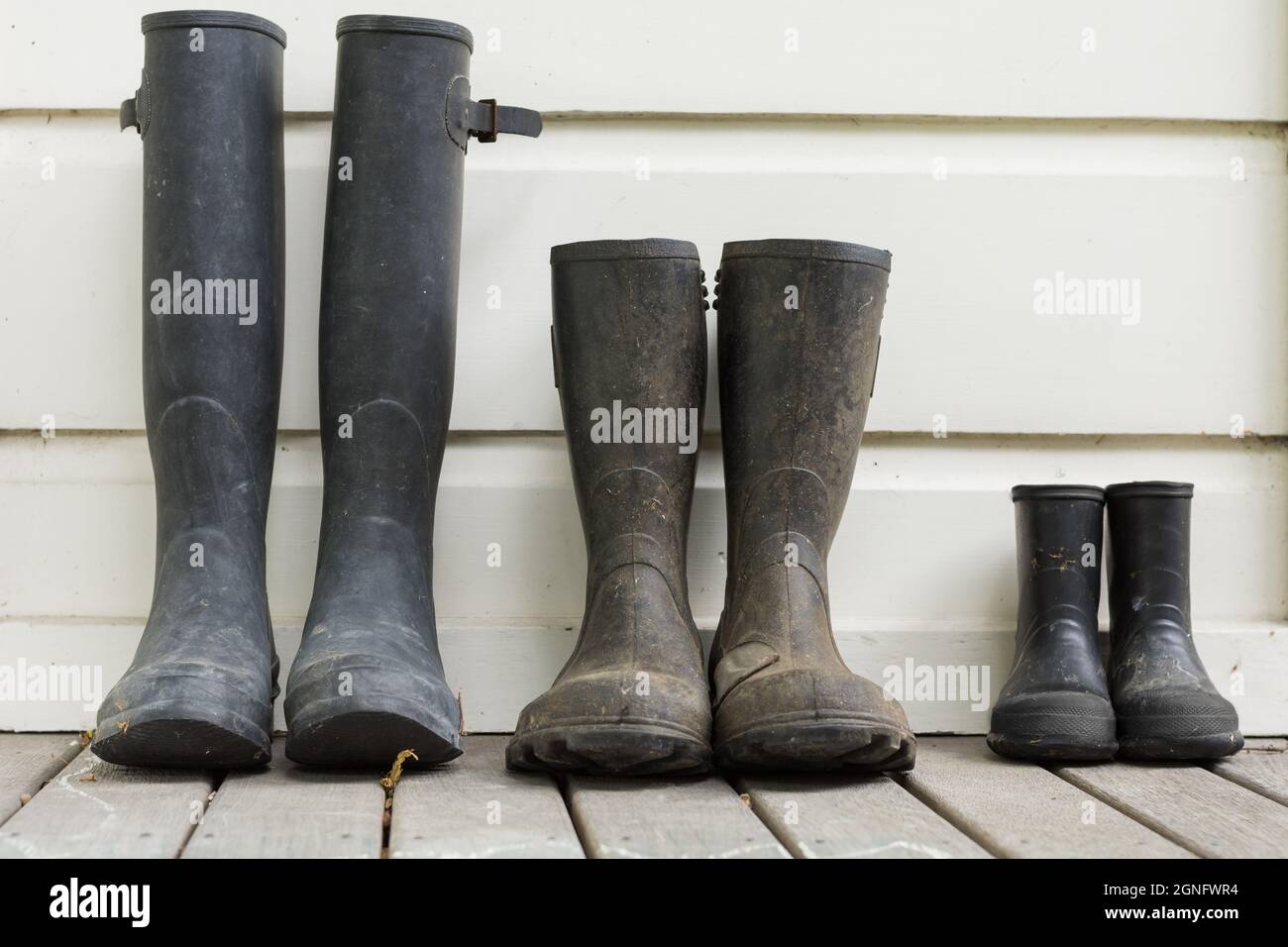 Pairs of boots in a row decreasing in size Stock Photo - Alamy