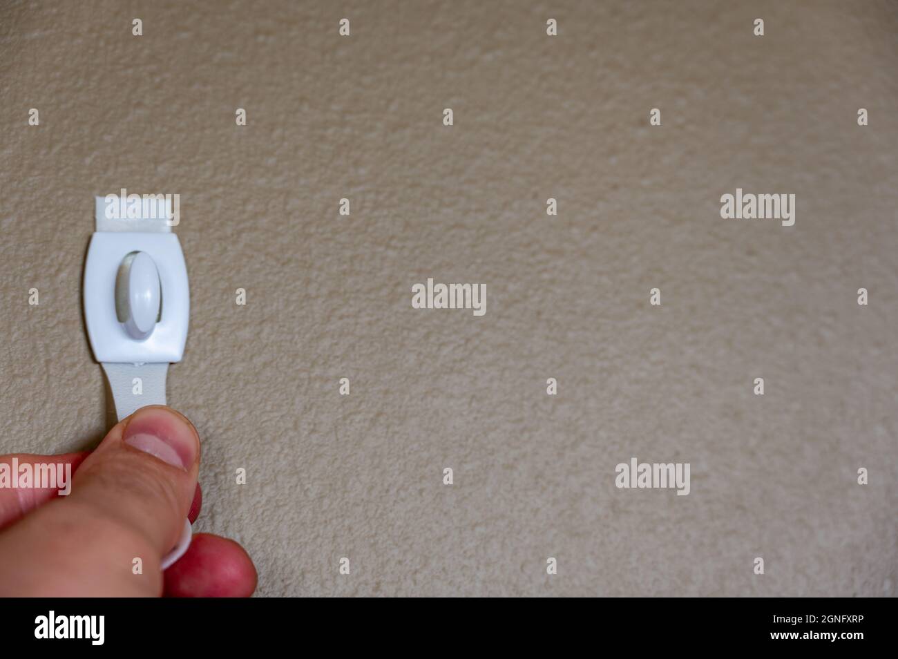 Selective focus on adhesive strip wall hanger that can be removed by ...