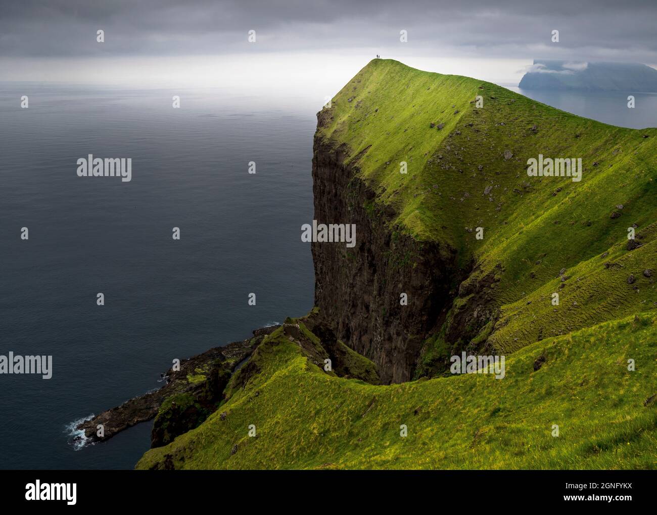 The epic and dramatic sea cliffs by the Kallur Lighthouse on Kalsoy ...