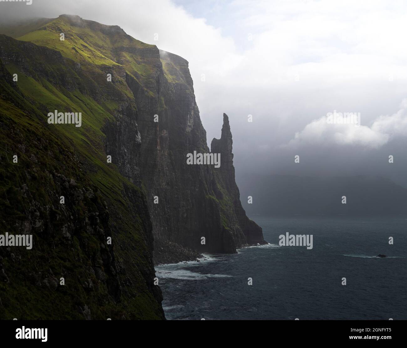 The dramatic Troll Witch's Finger rock formation / cliff during a moody ...
