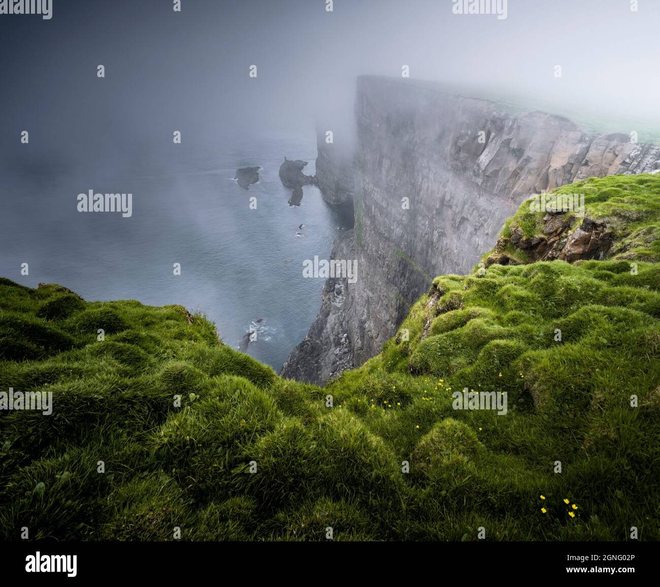 Dramatic Mykines sea cliffs in clouds and fog on the Faroe Islands ...