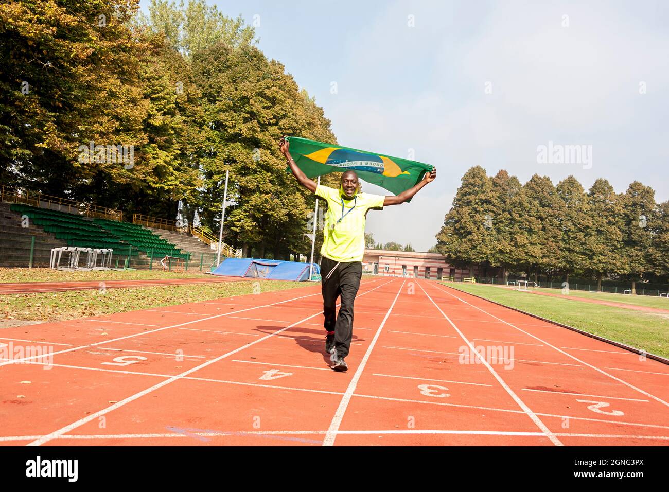 Brazilian runner athlete celebrates victory on the running track in the ...