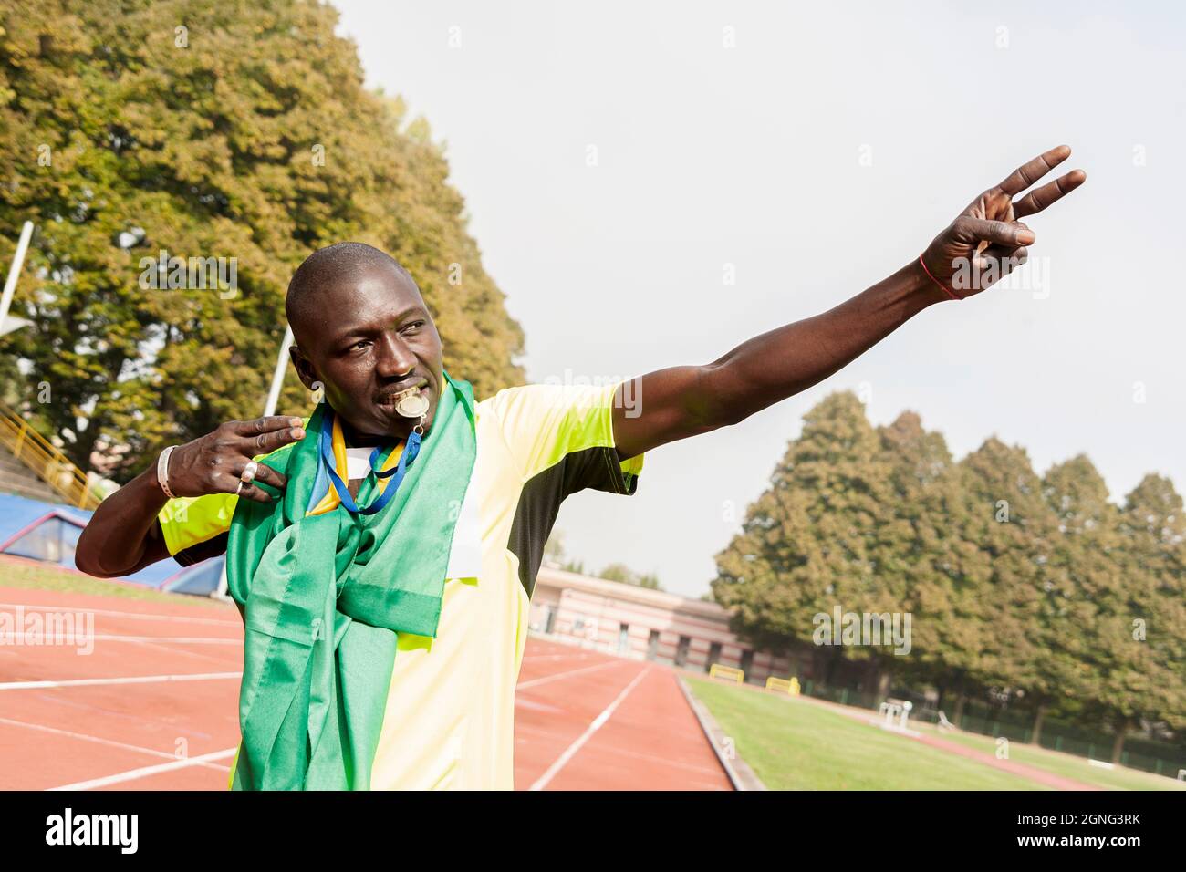 Brazilian runner athlete celebrates victory on the running track in the ...