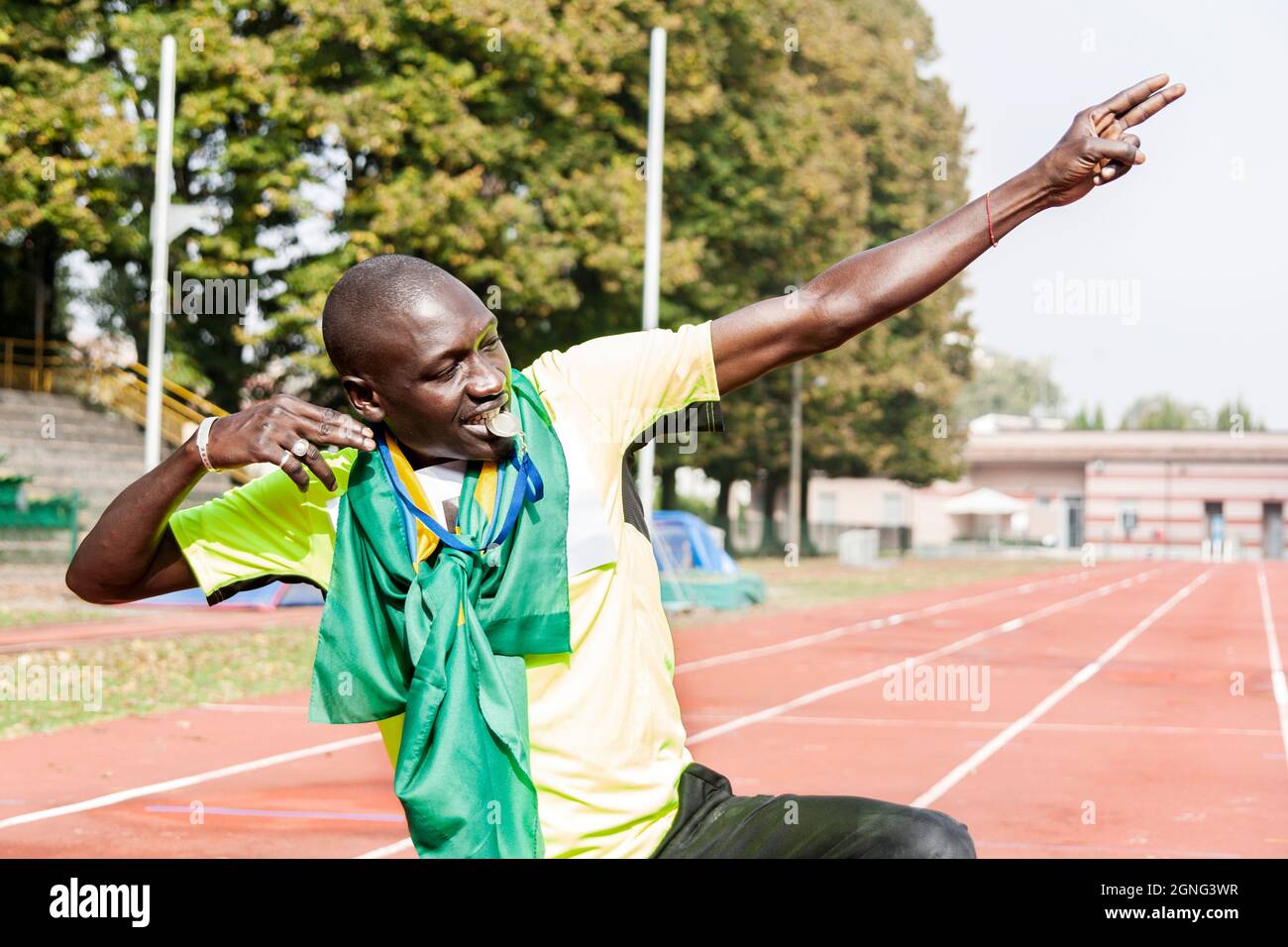 Brazilian runner athlete celebrates victory on the running track in the ...