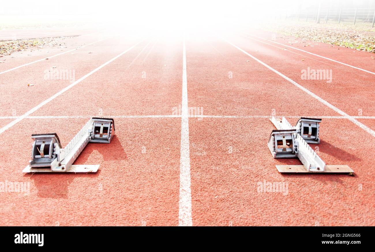 starting blocks on red running tracks Stock Photo - Alamy
