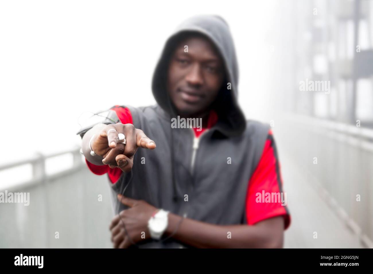 African American athlete member of a gang shows the symbol of the horns ...