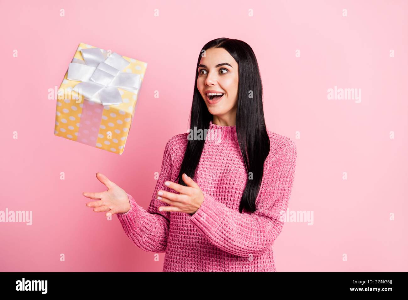 Photo portrait of cheerful woman throwing present box up in air ...