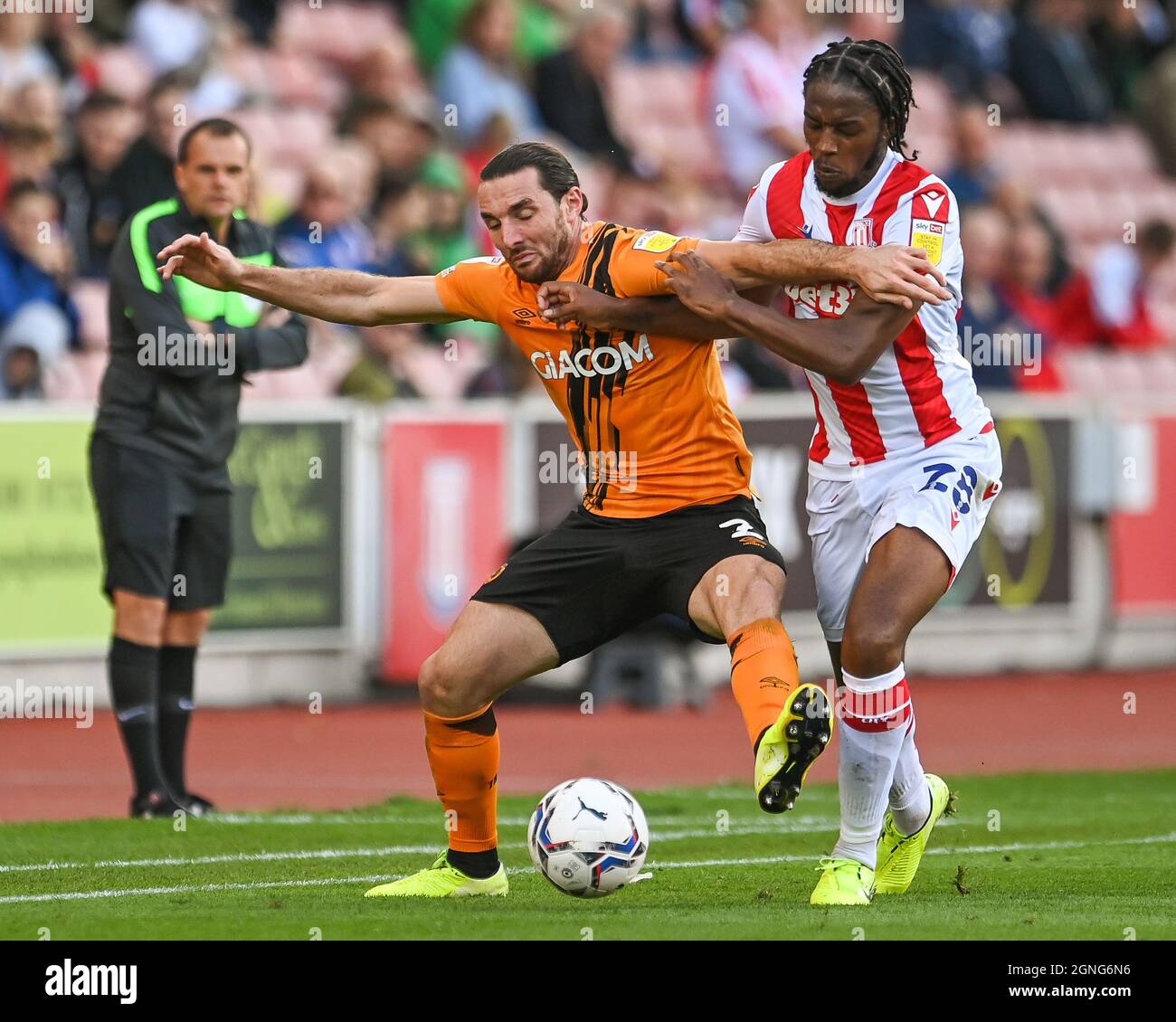 Lewie Coyle #2 of Hull City battles for the ball with Romaine Sawyers ...