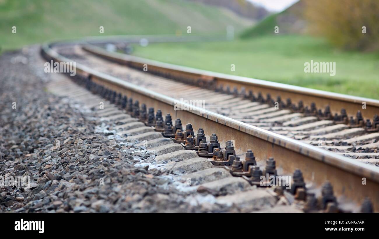 Selective focus railway track turns and twists between out of focus ...
