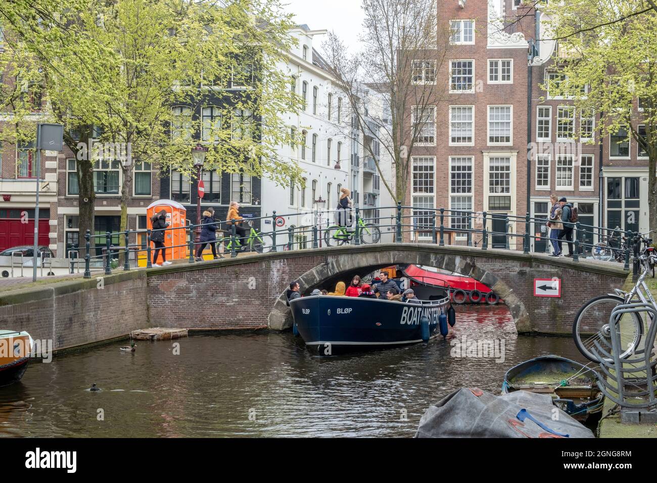 Amsterdam, The Netherlands - April 2019: Tourist boat passing under ...