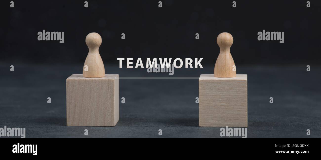 Two wooden people connect to build a team, working together Stock Photo ...