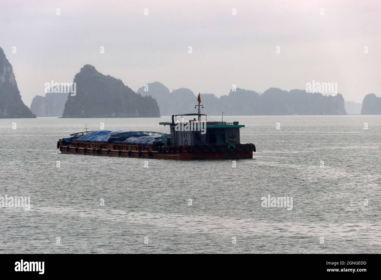 Shipping in Halong Bay, Vietnam. Self-propelled barges (medium landing craft). Against the ...