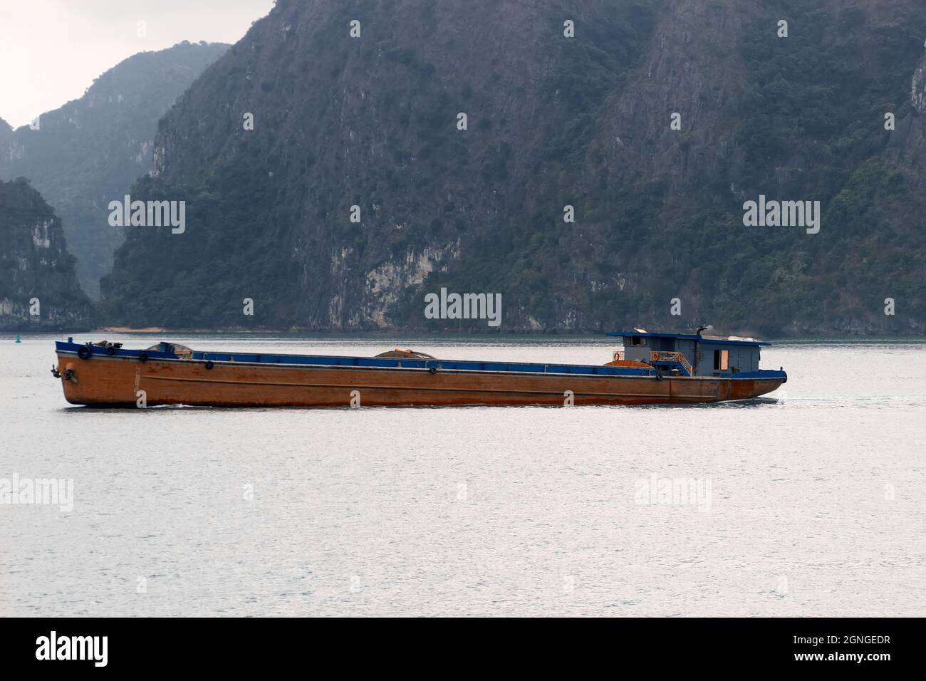 Shipping in Halong Bay, Vietnam. Self-propelled barges (medium landing craft). Against the ...