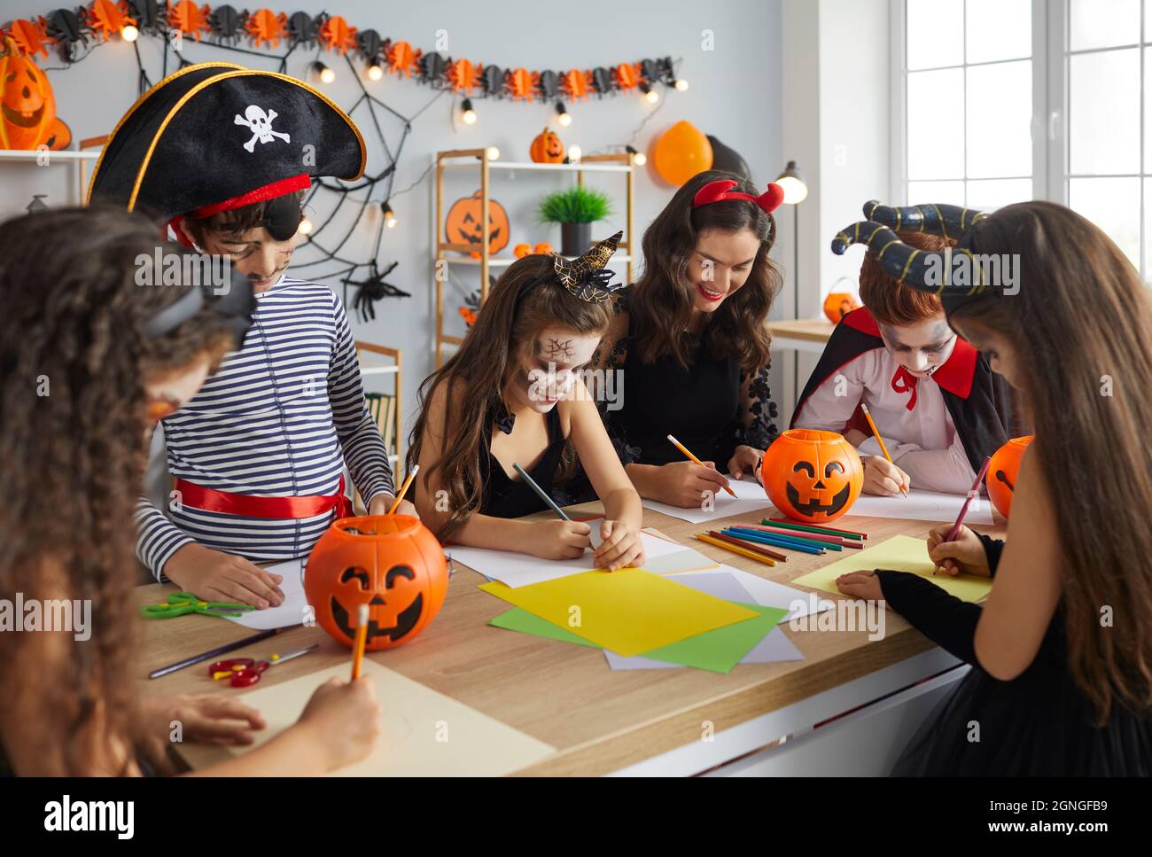 Arts and Crafts teacher and children dressed up in costumes having fun ...