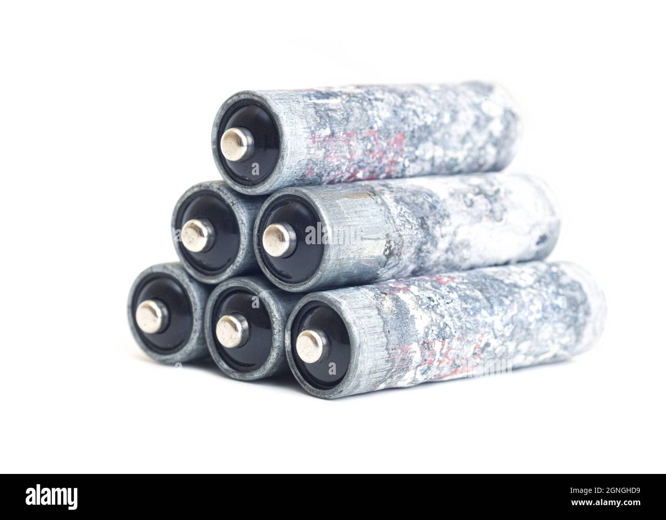 Pyramid made of six heavily corroded AA batteries isolated on white ...