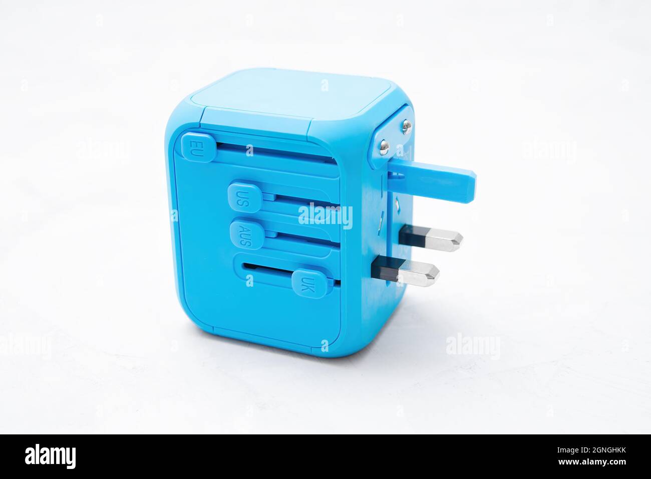 Close-up of an all-in-one universal power adapter travel plug on white ...