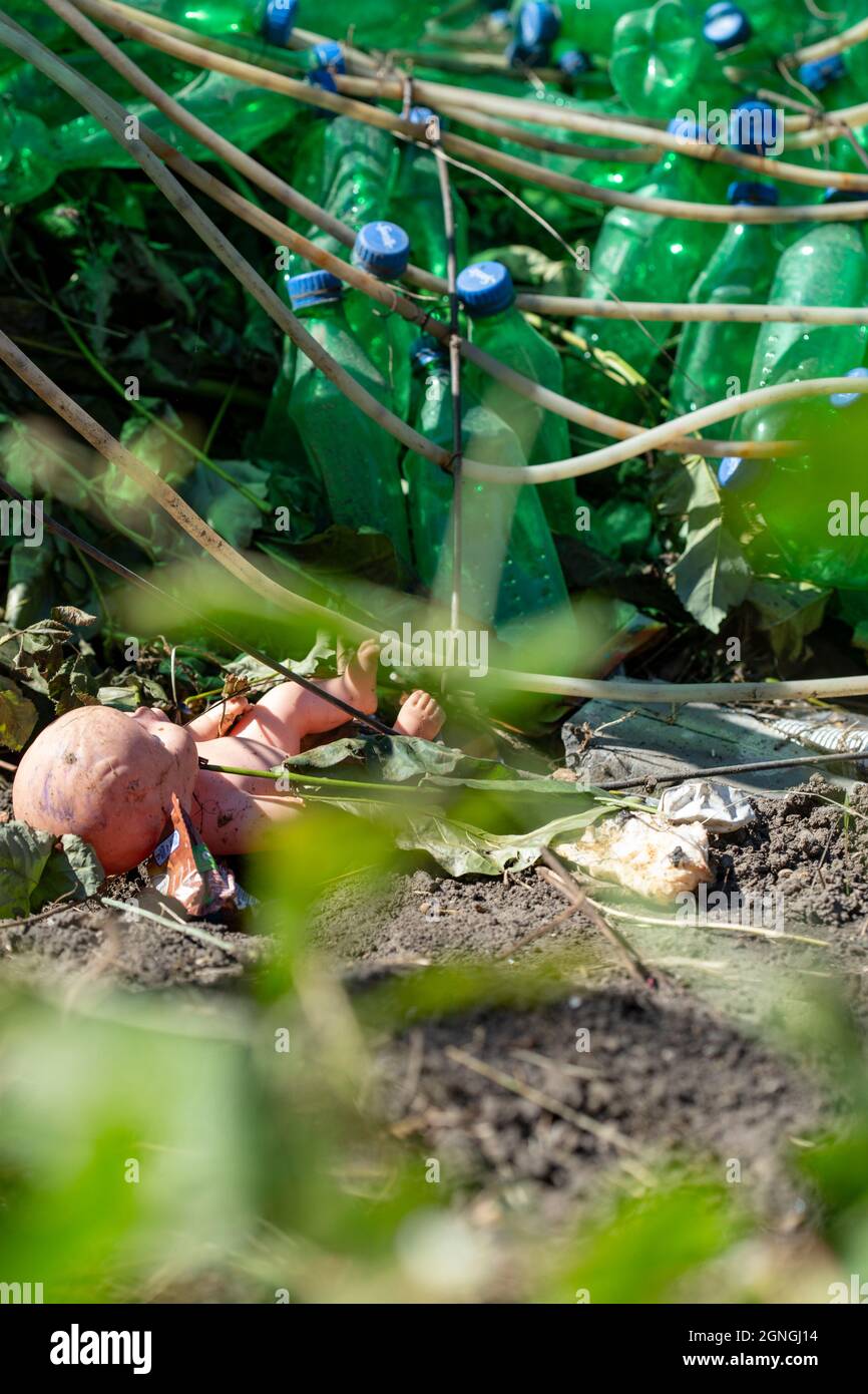 abstract composition with a plastic doll and a lot of sprite plastic ...