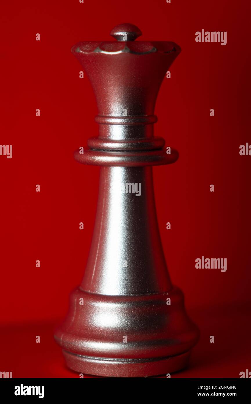 Closeup of a chess queen figure isolated on a red background Stock ...