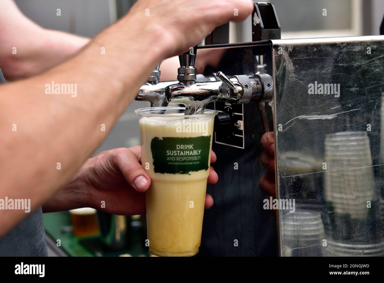 Pulling a pint of beer with logo “drink Sustainably and Responsibly” on ...
