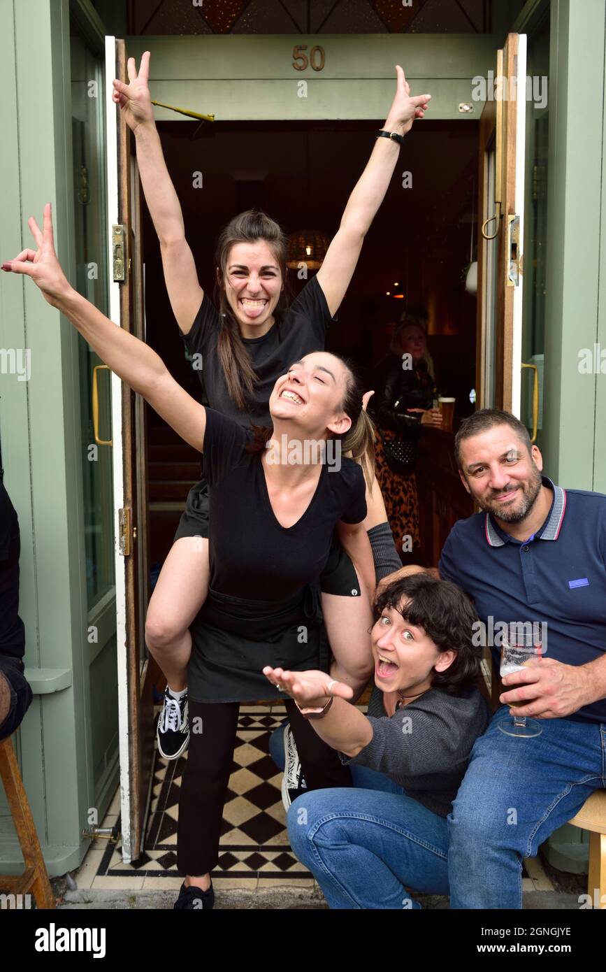 Happy group of exuberant friends in doorway Stock Photo - Alamy