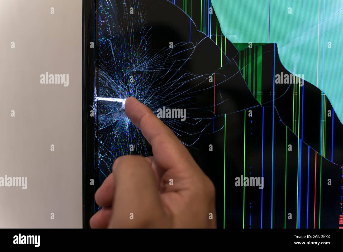 the lcd monitor screen is broken. a man's hand touches a crack Stock ...