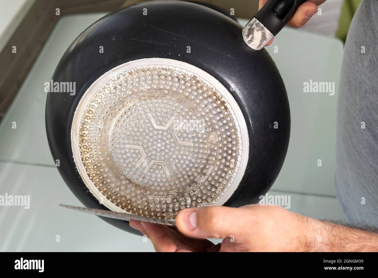 the pan is damaged. the bottom of the dish fell off Stock Photo - Alamy