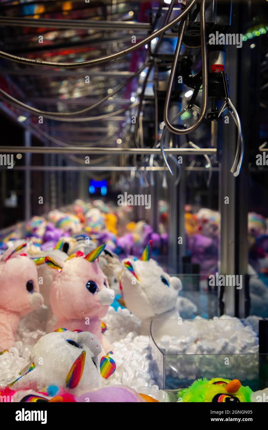 Claw machine Toy Arcade game filled with unicorns childrens toys Stock ...
