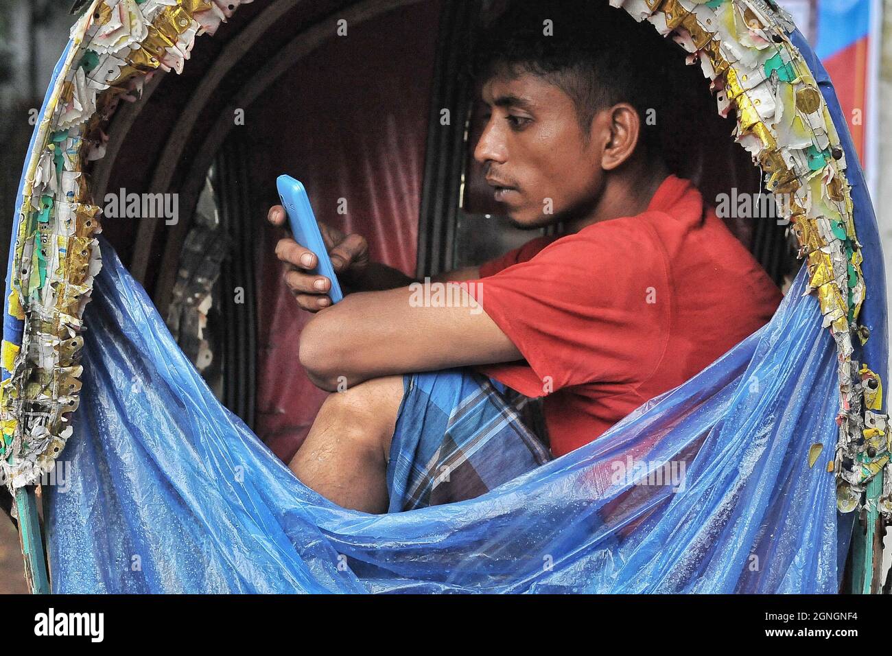 Life as a Bihari. A boy with a phone in his tent. ‘Biharis’ refers to ...