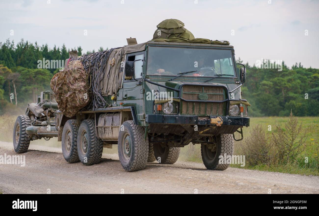 British army Pinzgauer High-Mobility All-Terrain 6x6 vehicle tows a ...