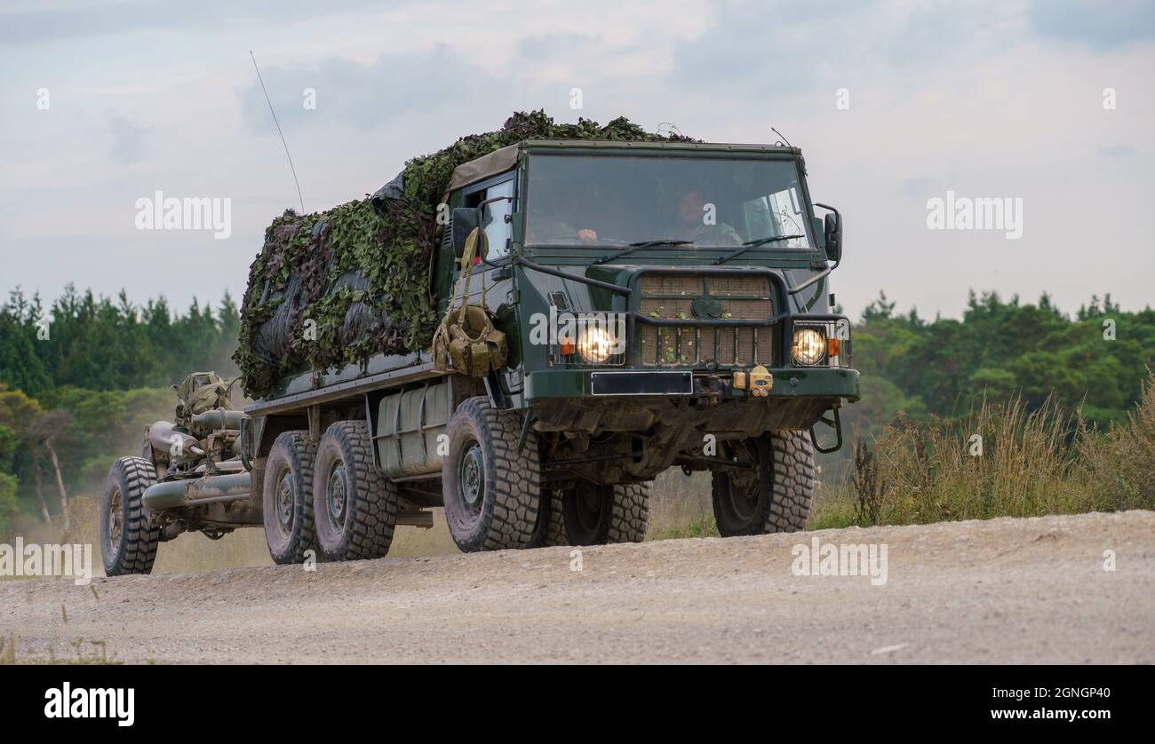 British army Pinzgauer High-Mobility All-Terrain 6x6 vehicle tows a ...