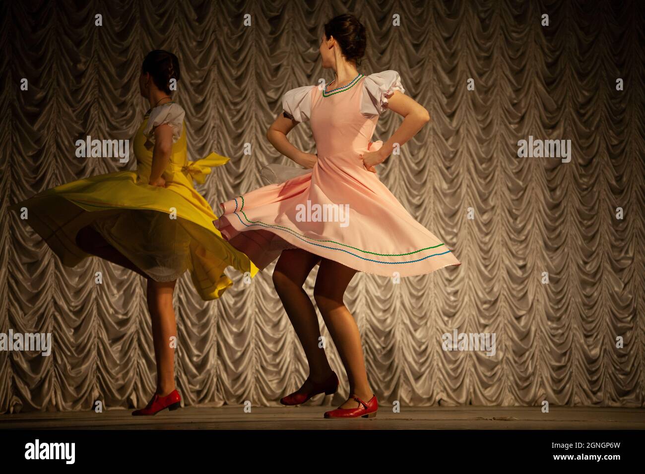 The girls dance. Russian girls dance on stage. Dance lesson in long ...