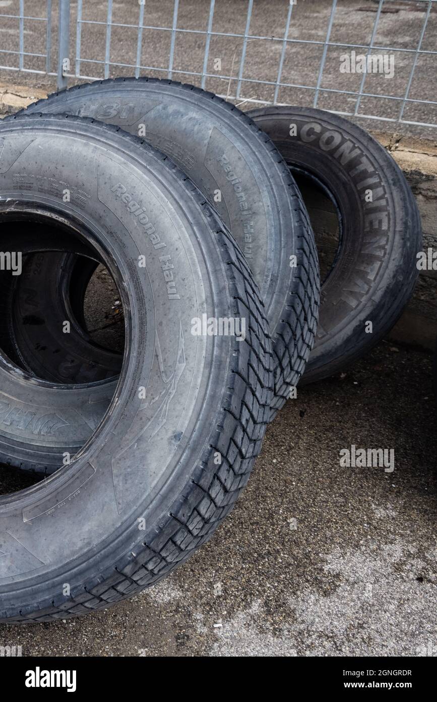 Stack of old used tires of different sizes and types in abandoned scrap ...