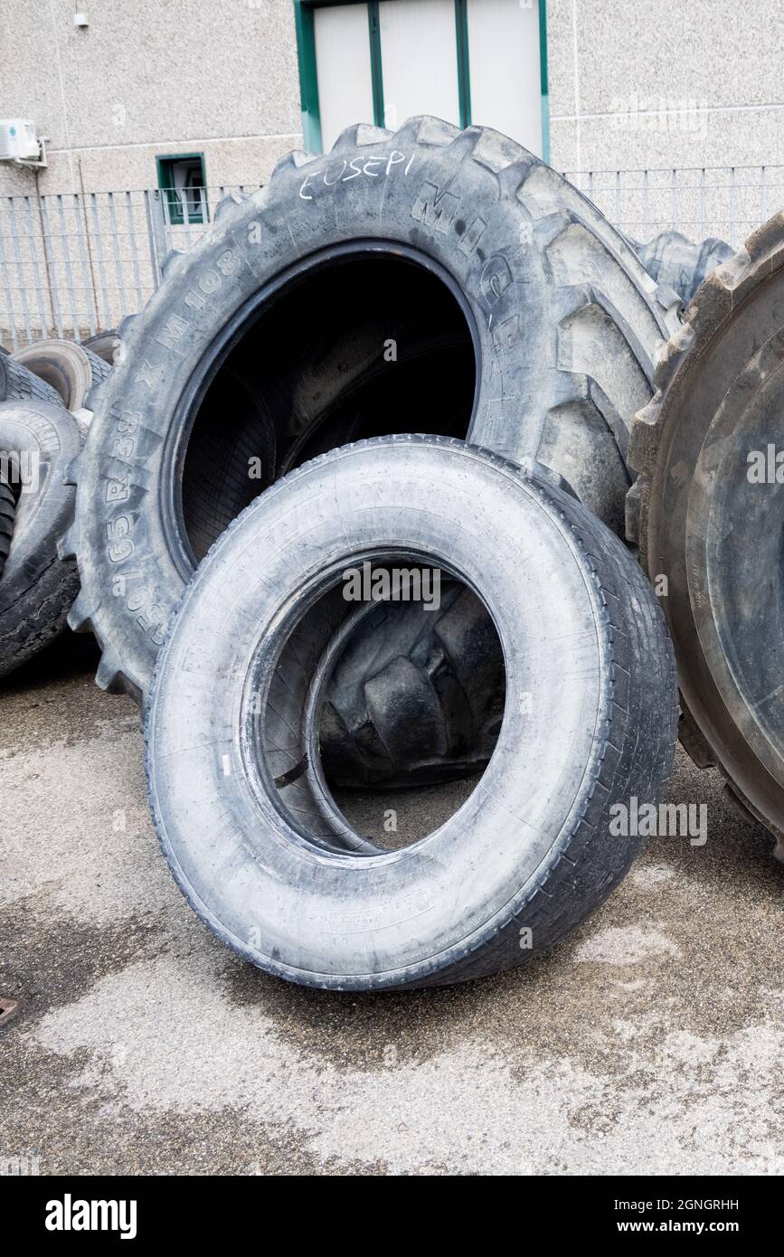 Stack of old used tires of different sizes and types in abandoned scrap ...
