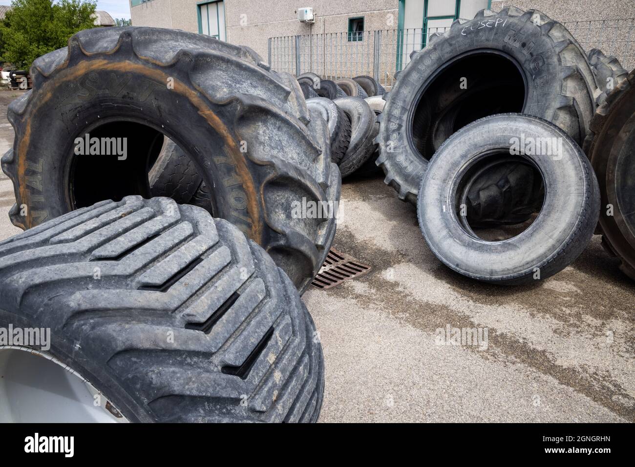 Stack of old used tires of different sizes and types in abandoned scrap ...