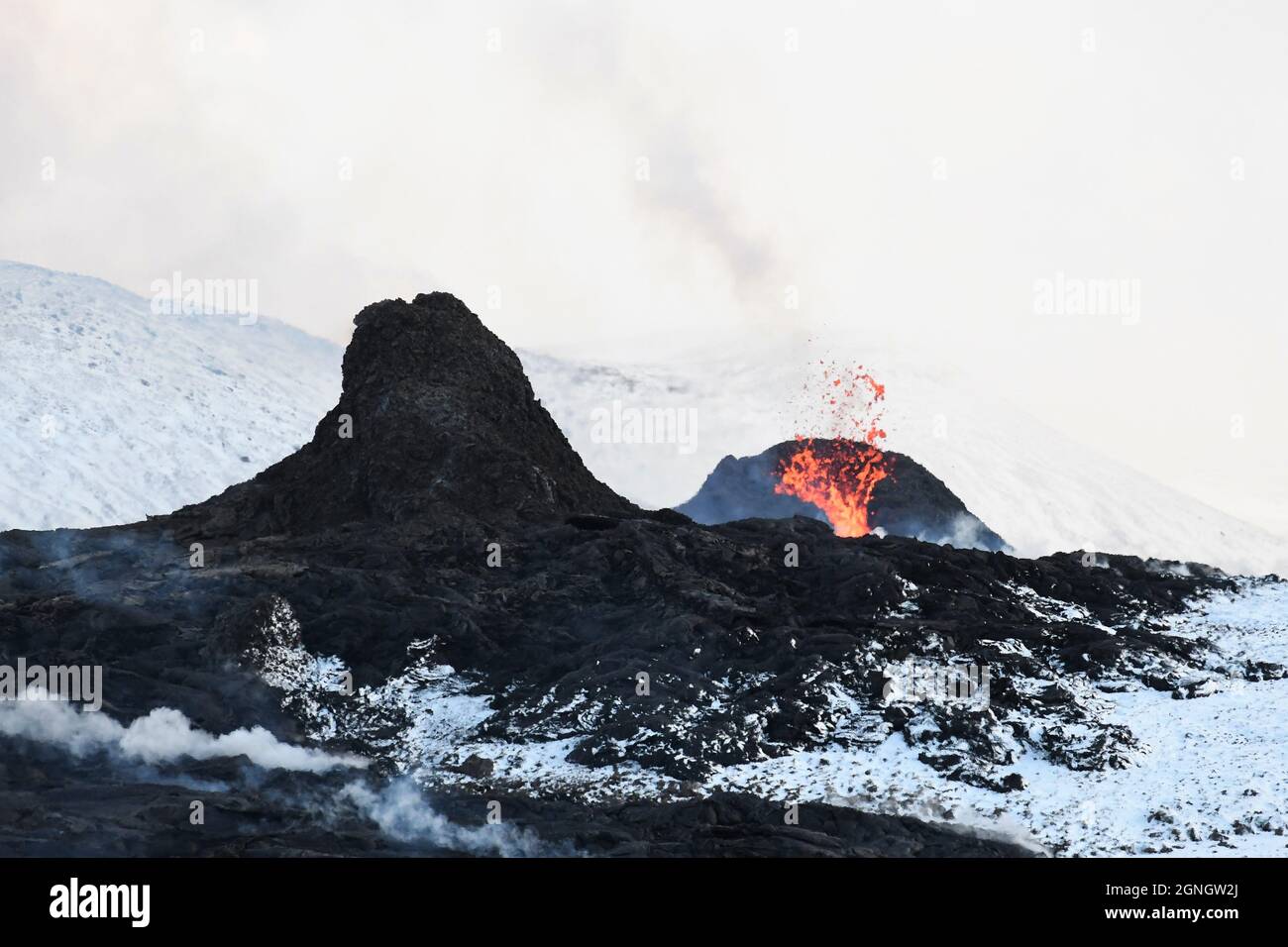 Two vents at the Fagradalsfjall eruption in Iceland. Black lava field ...