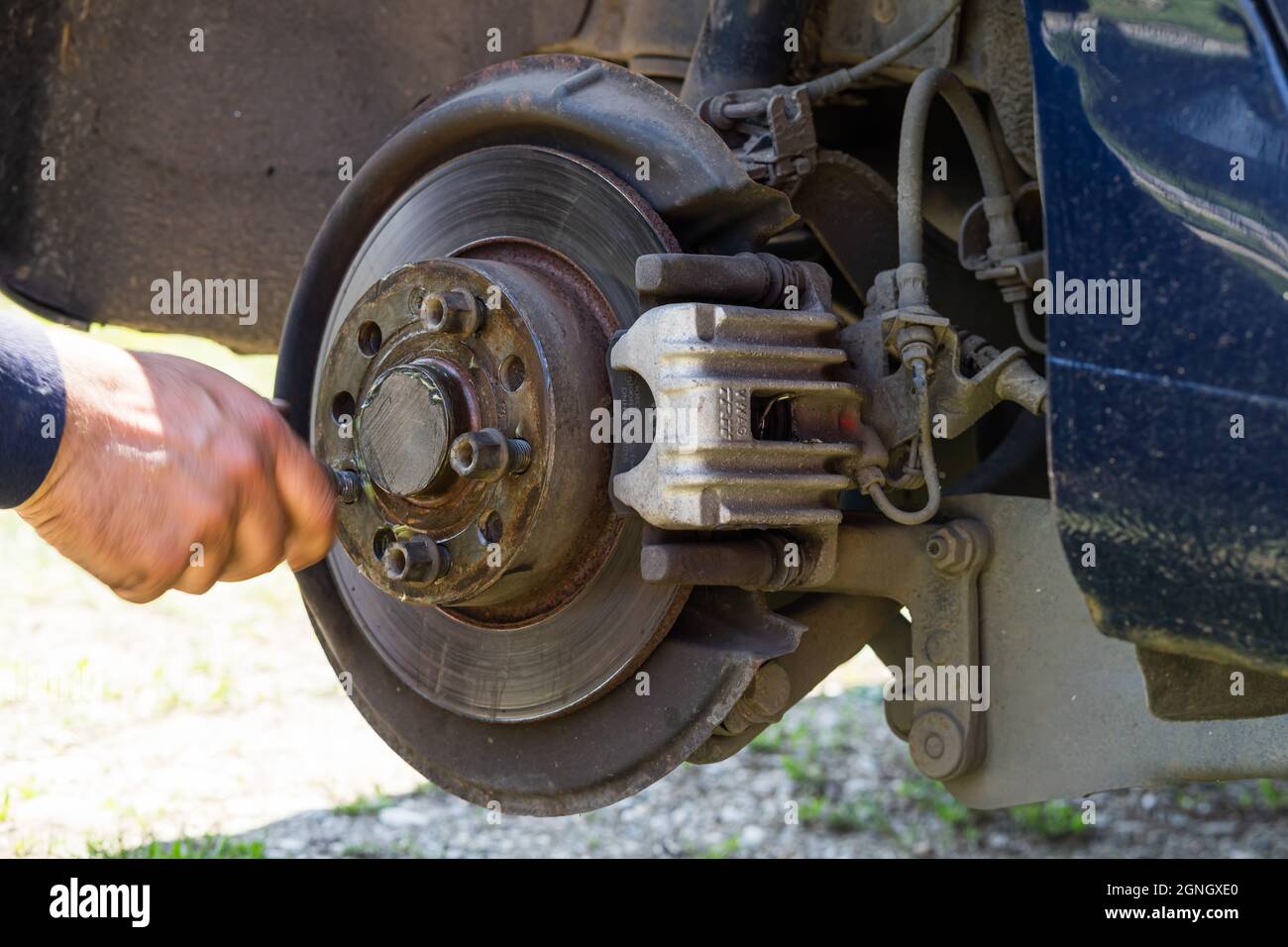 Mechanic cleaning and fixing the brake system of a car in Romania ...