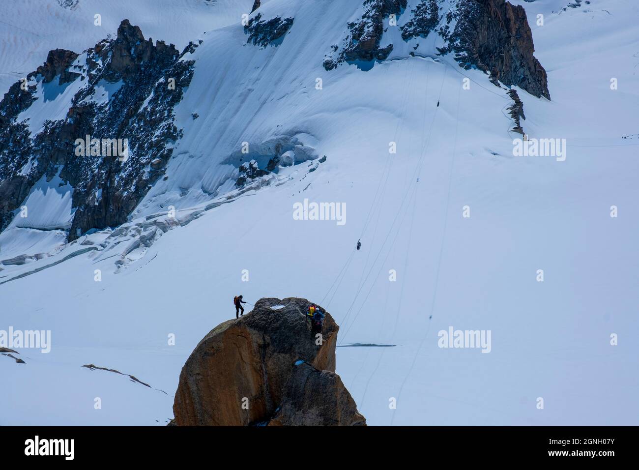 Mountain landscape with alpinist climbing Aiguille du Midi at 3842m ...