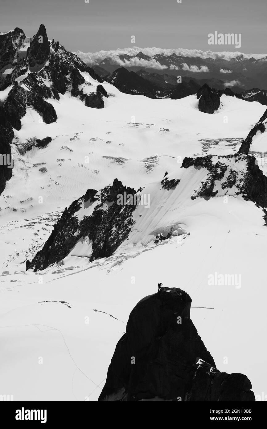 Mountain landscape with alpinist climbing Aiguille du Midi at 3842m ...