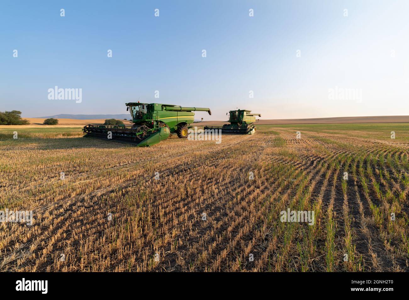 John Deere combines parked in a farm field in Idaho, USA Stock Photo ...