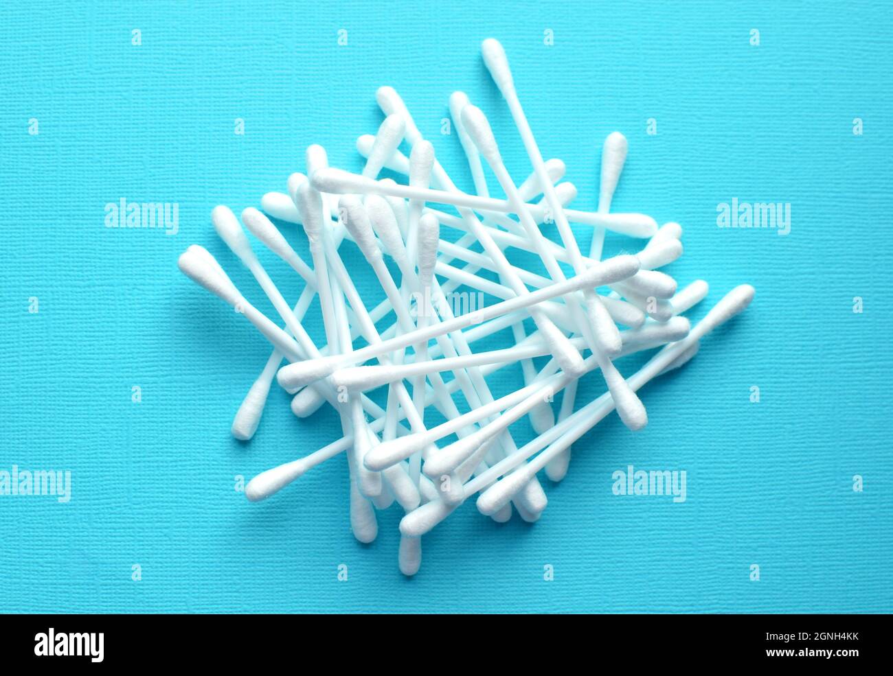Lots of plastic cotton swabs on a blue background Stock Photo - Alamy