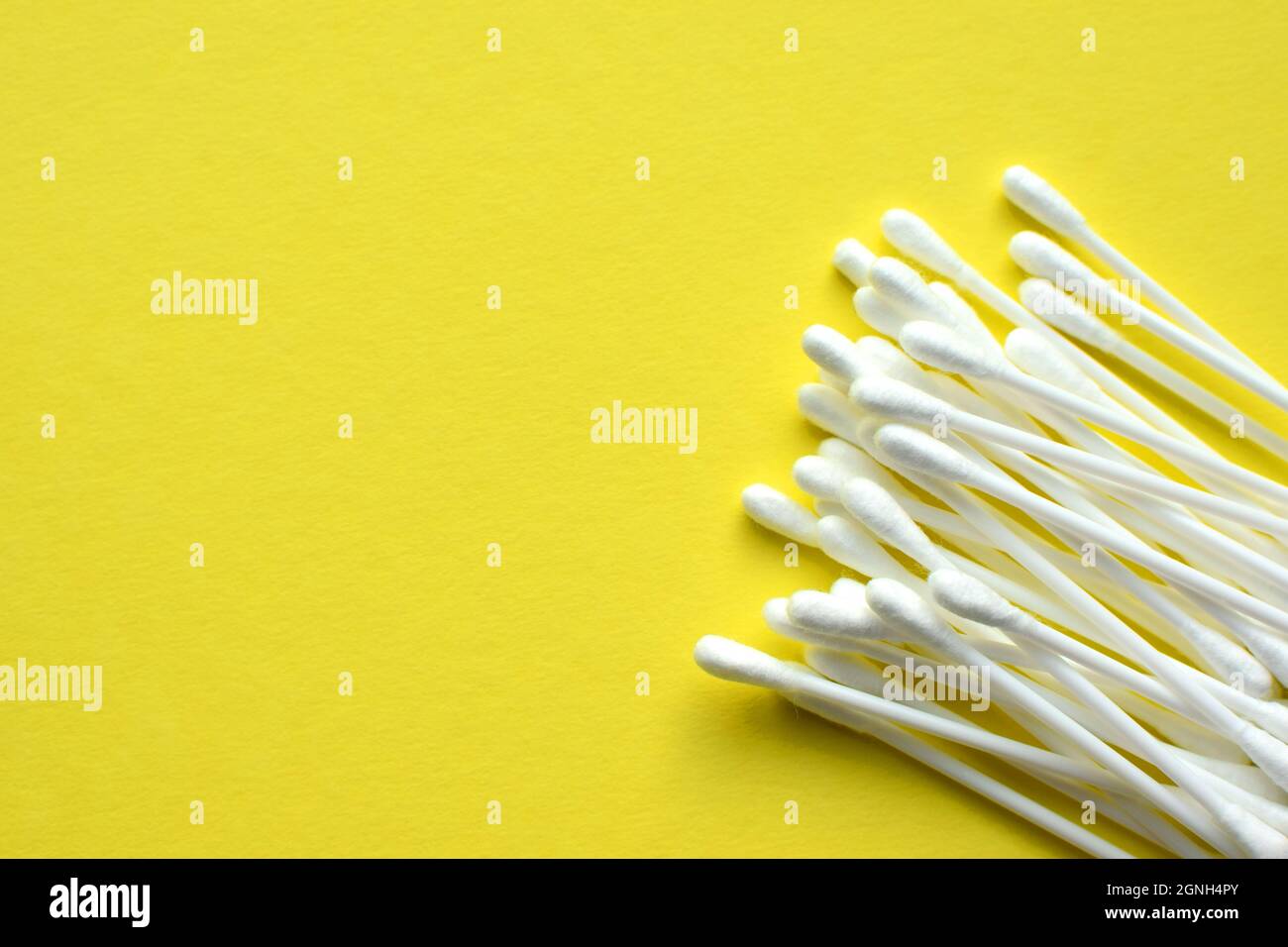 Lots of plastic cotton swabs on a yellow background Stock Photo - Alamy