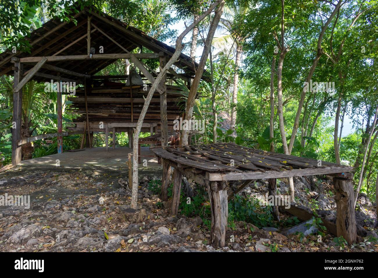 Old abandoned outdoor alcove and a benchbuilt with wood in the forest ...