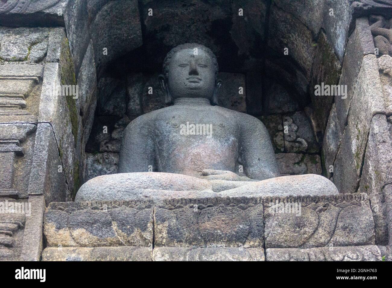 Low angle shot of a praying religious stone sculpture in the wall Stock ...